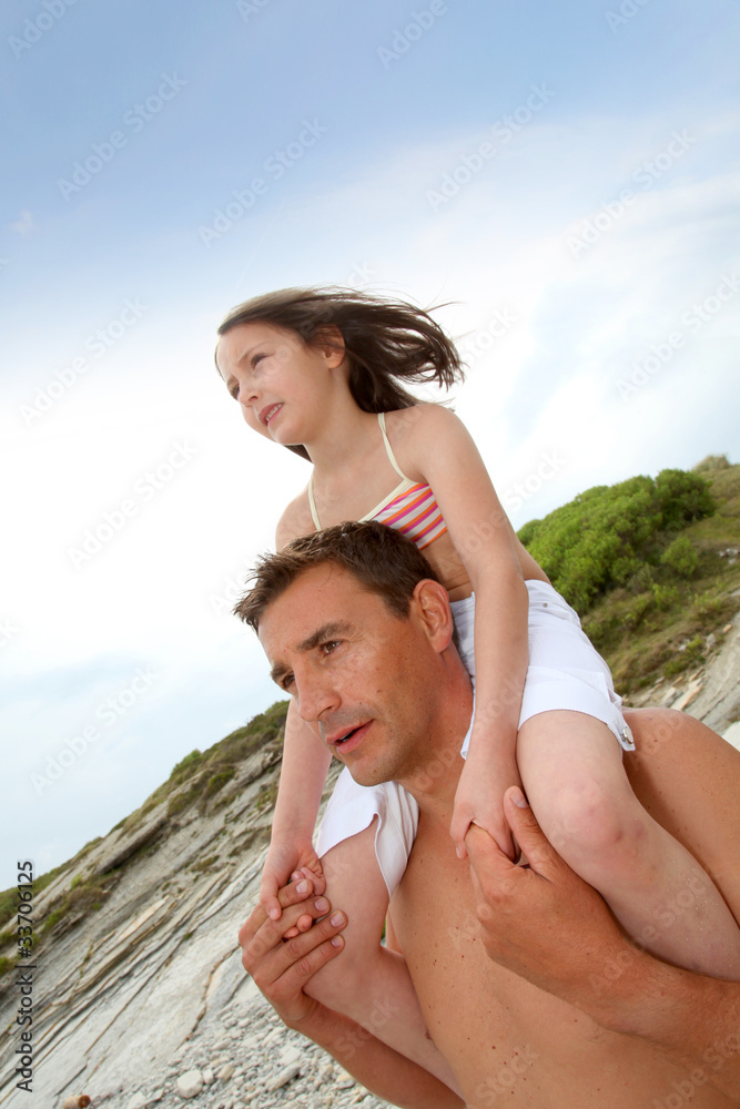 Father carrying daughter on his shoulders Stock Photo | Adobe Stock