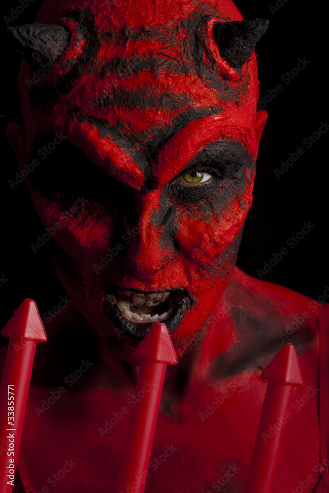 Devil and trident, dark background. Stock Photo | Adobe Stock