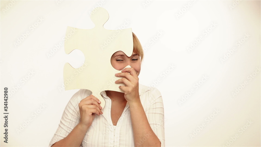 Woman hiding behind jigsaw piece Stock Video | Adobe Stock