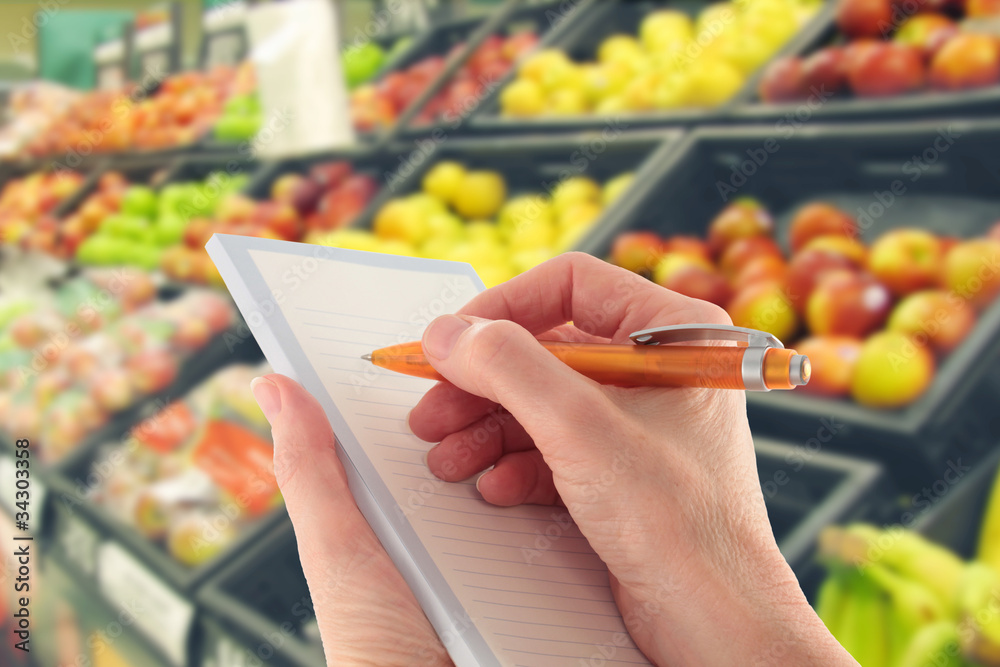 Hand with Pen Writing a Shopping List by Supermarket Fruit Stock Photo ...