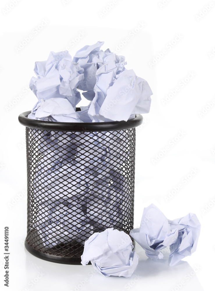 Full wire mesh trash can with crumpled paper scattered around Stock ...
