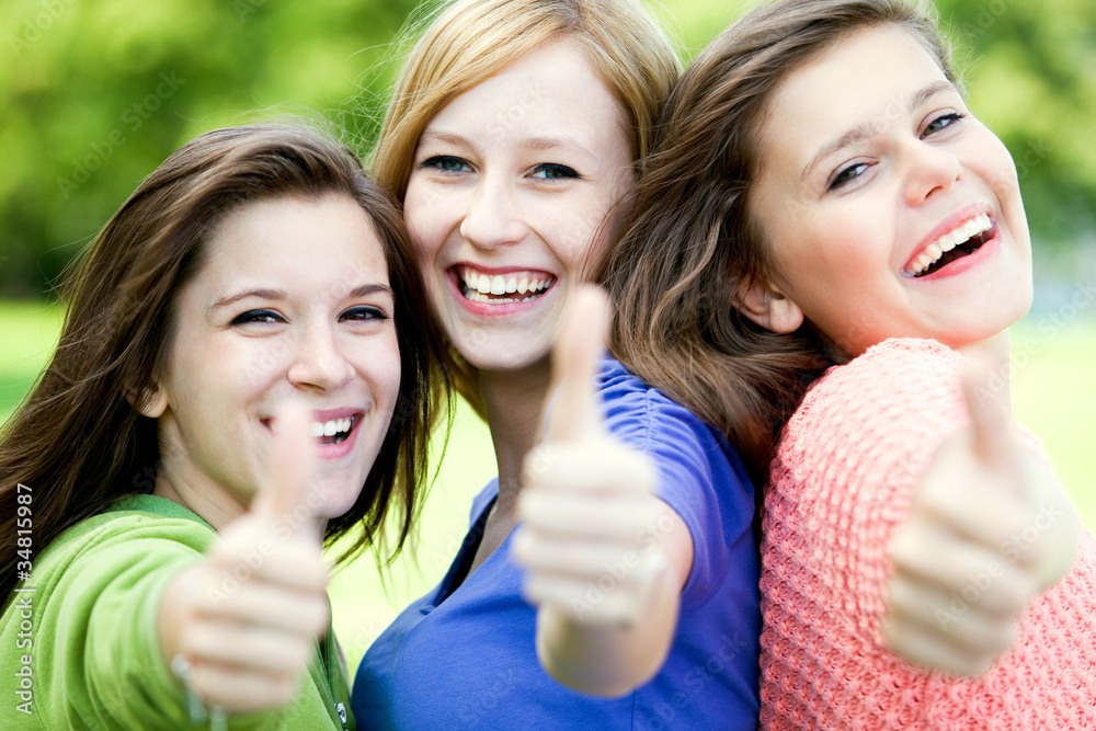 Friends showing thumbs up sign Stock Photo | Adobe Stock