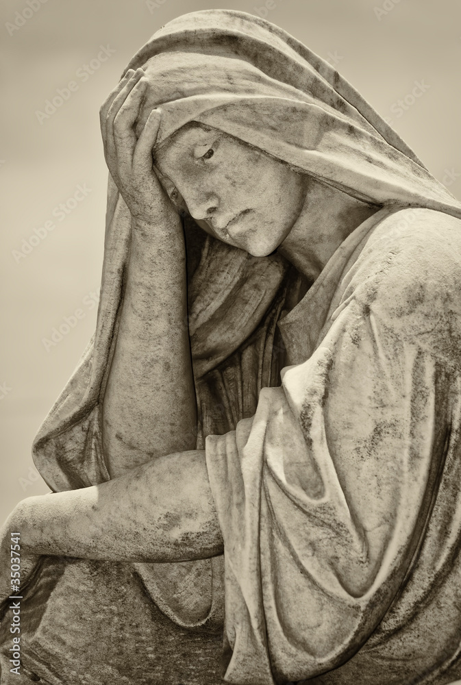 Old statue of a suffering woman with a vintage sepia look Stock Photo ...