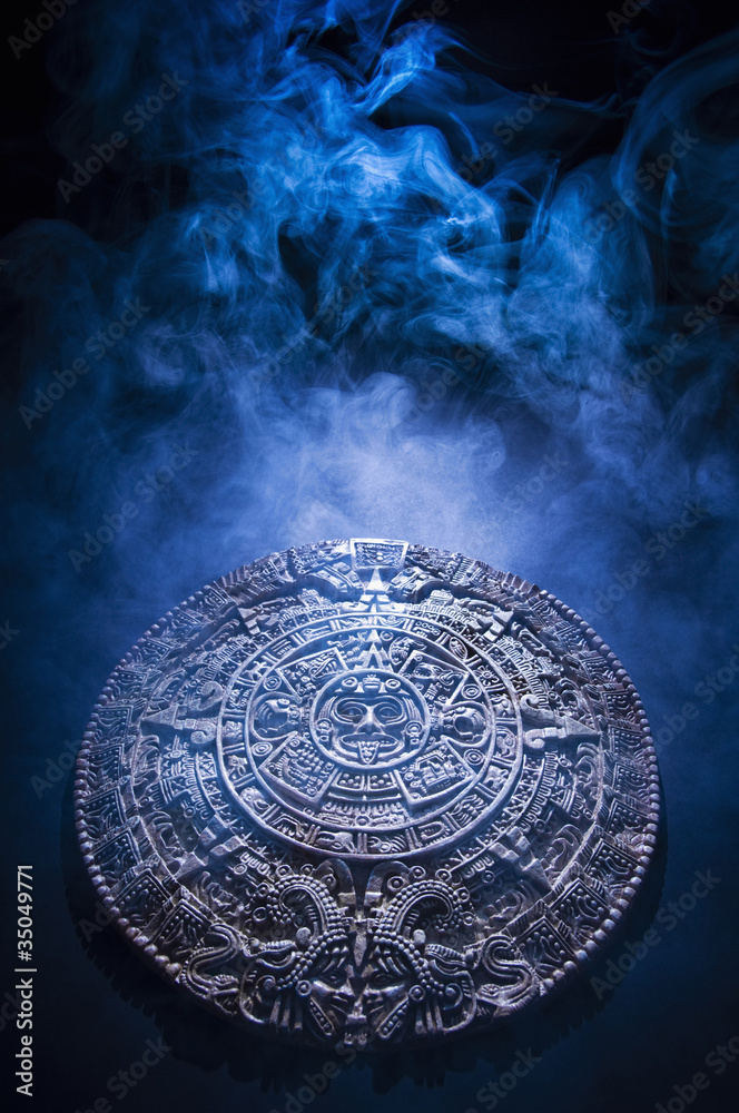 Aztec calendar stone carving surrounded by smoke Stock Photo | Adobe Stock