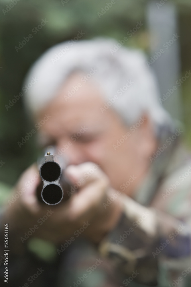 Senior Chilean man pointing shotgun Stock Photo | Adobe Stock