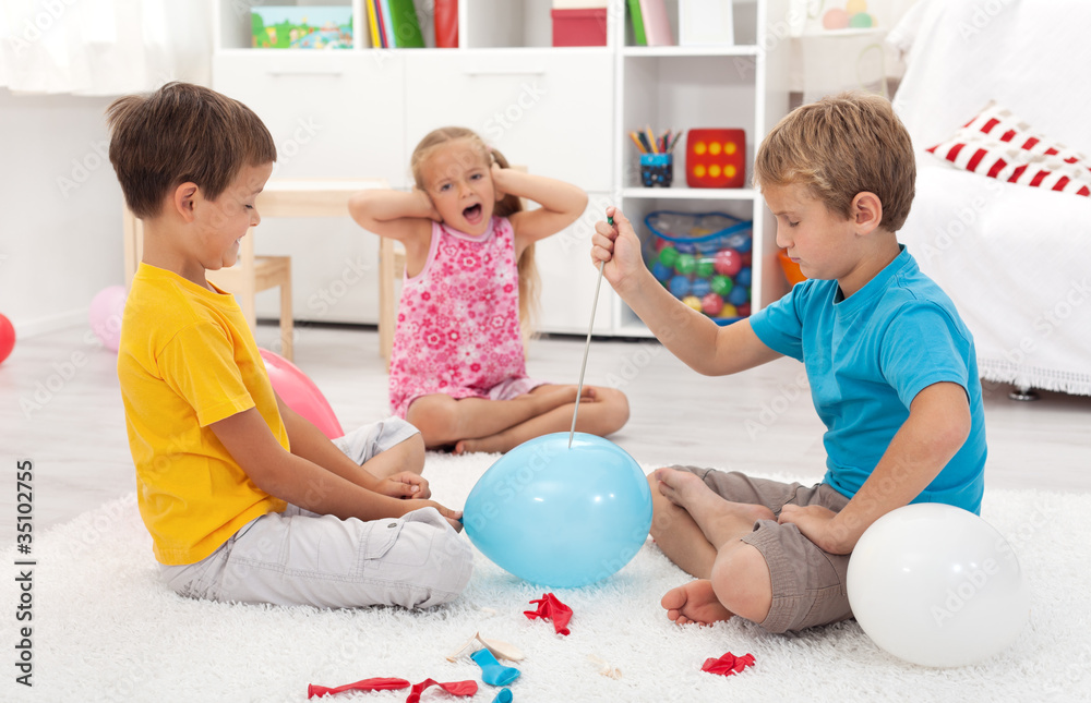 Kids popping balloons Stock Photo | Adobe Stock