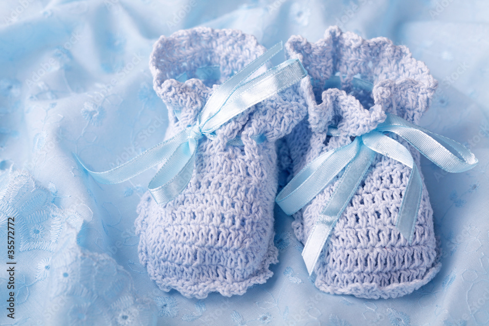 Blue baby booties on blue background Stock Photo | Adobe Stock
