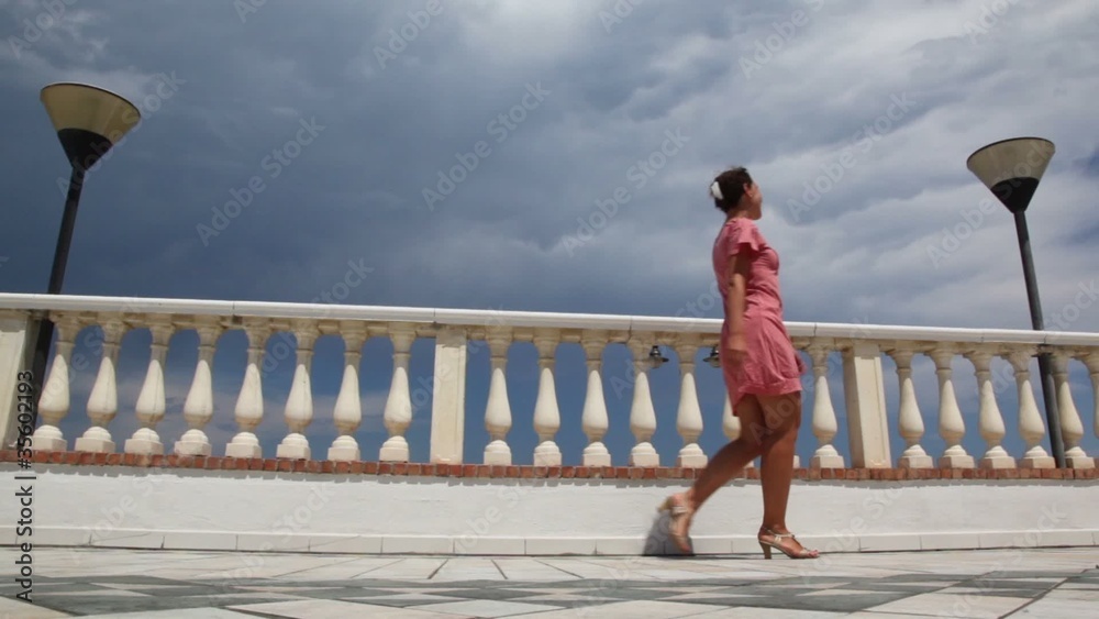 Woman goes from left to right along the balustrade Stock-Video | Adobe ...