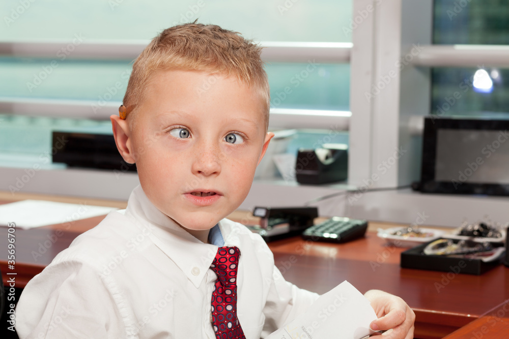 Cute boy with goofy face in business attire in an office Stock Photo ...
