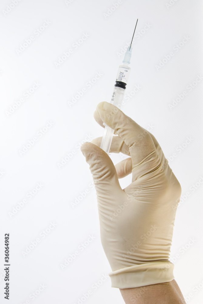 Gloved Hand Holding Hypodermic Needle Stock Photo | Adobe Stock