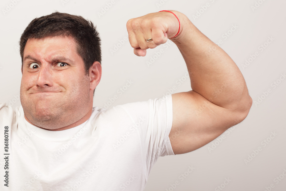 Image of a funny man flexing his arm Stock Photo | Adobe Stock