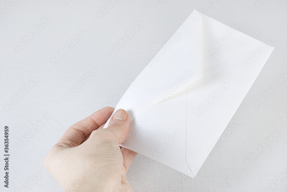 Female hand holding an envelope over white background. Not isola Stock ...