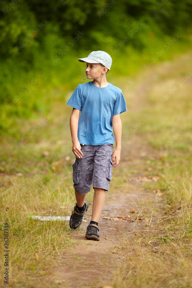 Boy walking in a forest Stock Photo | Adobe Stock