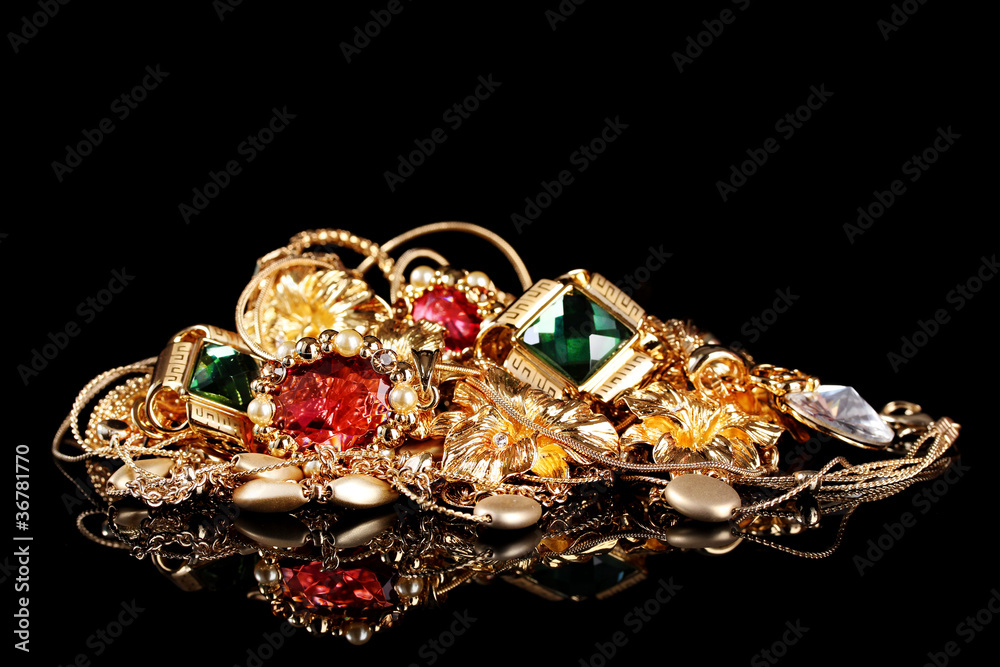 Various gold jewellery on black background Stock Photo | Adobe Stock