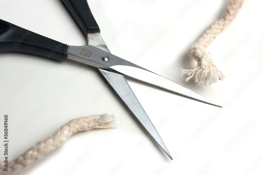 Scissors cutting a rope Stock Photo | Adobe Stock