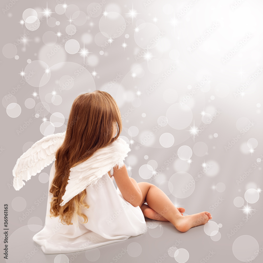Little angel thinking in divine light Stock Photo | Adobe Stock