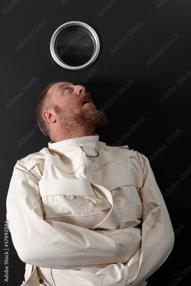 Paranoid man in a straitjacket Stock Photo | Adobe Stock