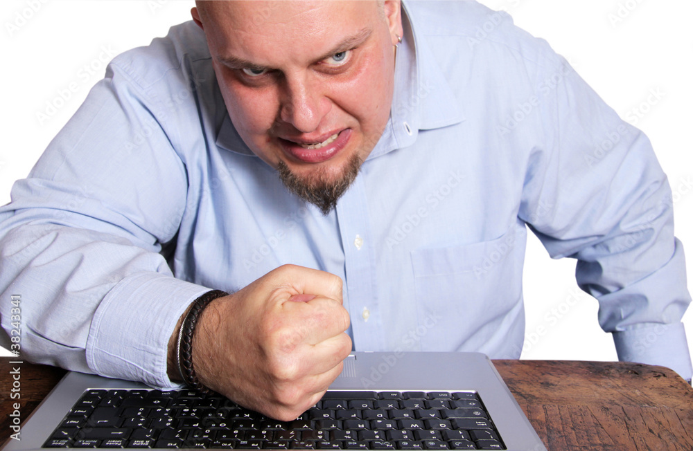 Angry man in front of computer giving a punch to keyboard Stock Photo ...