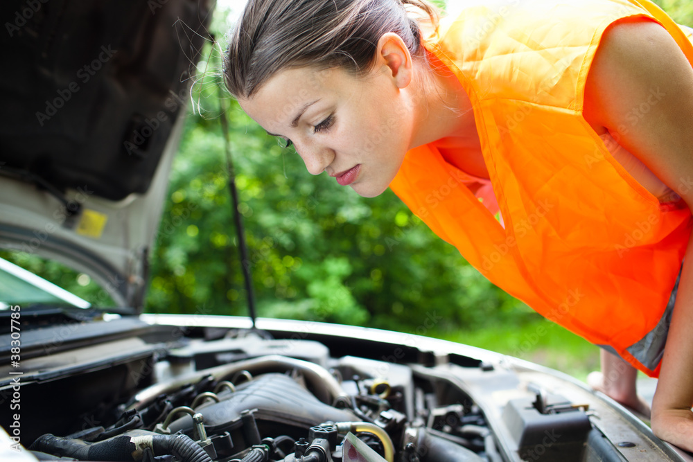 Young driver bent over the car engine Stock Photo | Adobe Stock