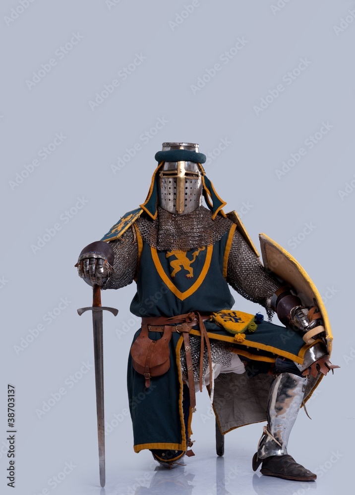 Medieval knight standing on his knee. Stock Photo | Adobe Stock
