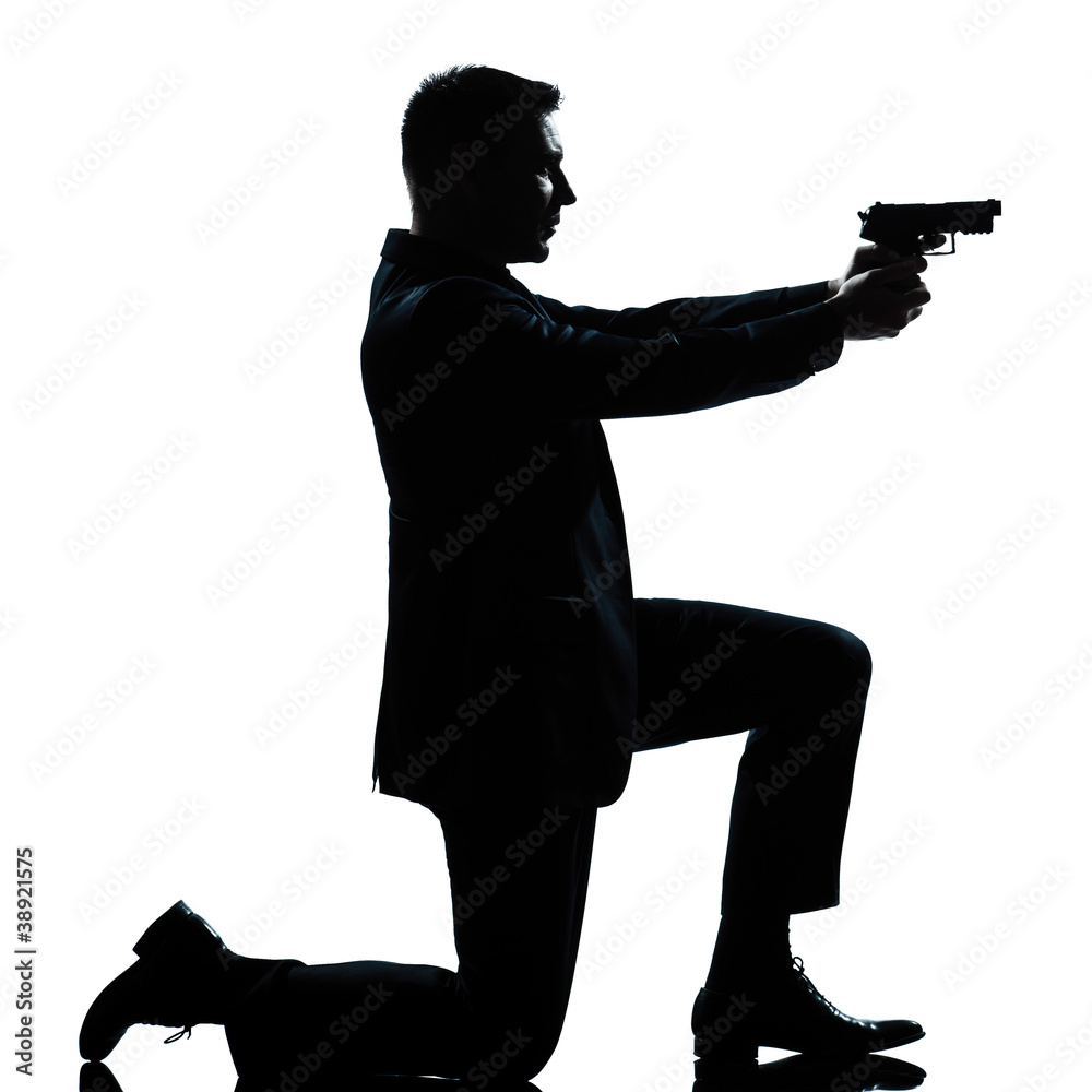 silhouette man kneeling aiming gun Stock Photo | Adobe Stock