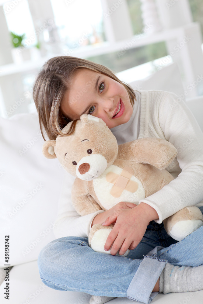 Sick little girl hugging sick teddy bear Stock Photo | Adobe Stock