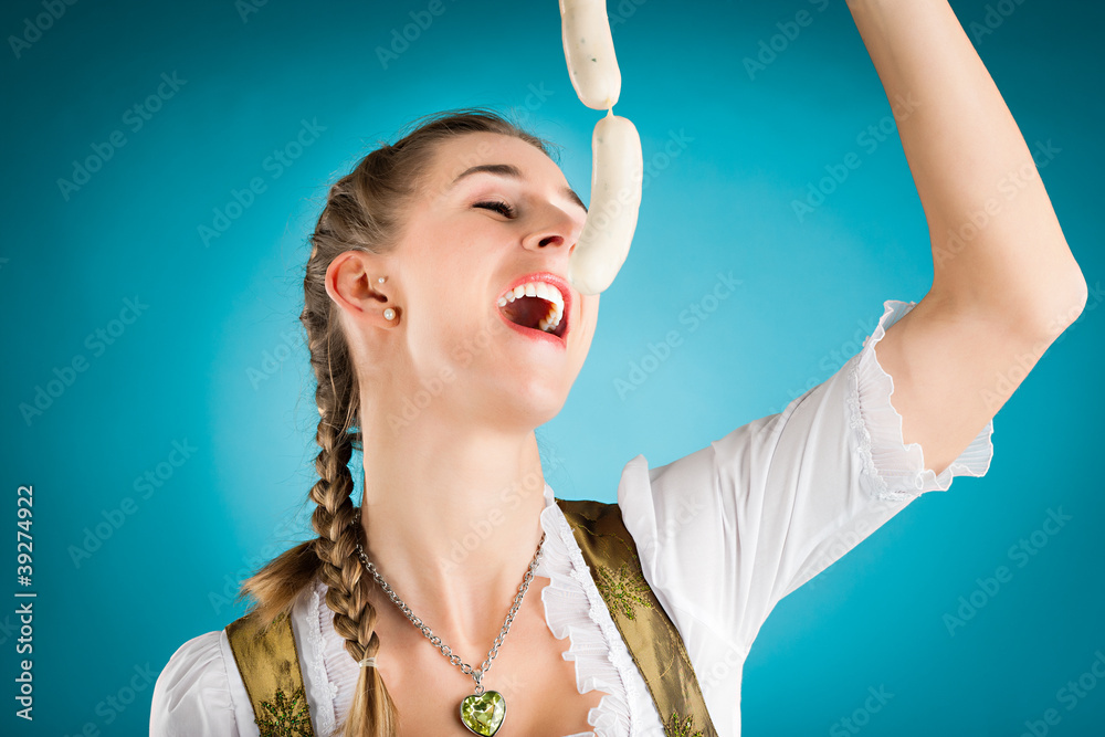 Junge Frau mit Weisswurst im Dirndl Stock Photo | Adobe Stock