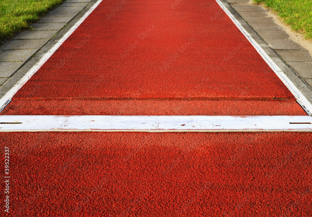 Long jump spring plank in an outdoor stadium Stock Photo | Adobe Stock