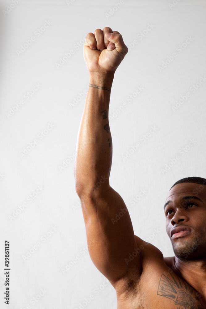 strong man toopless, arm raised in a fist Stock Photo | Adobe Stock