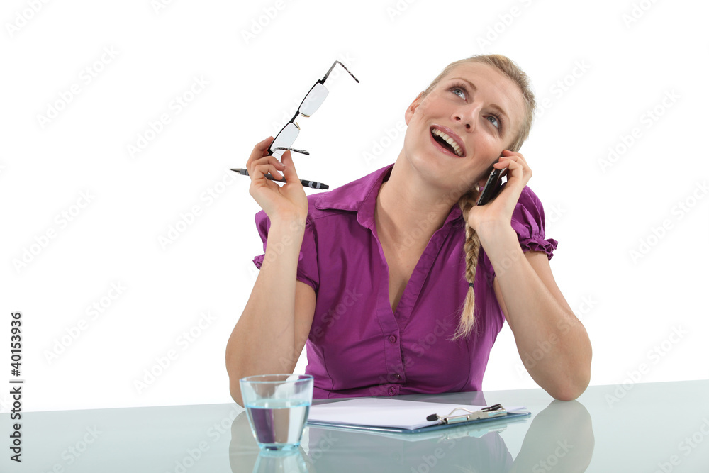 Woman gossiping on the phone Stock Photo | Adobe Stock