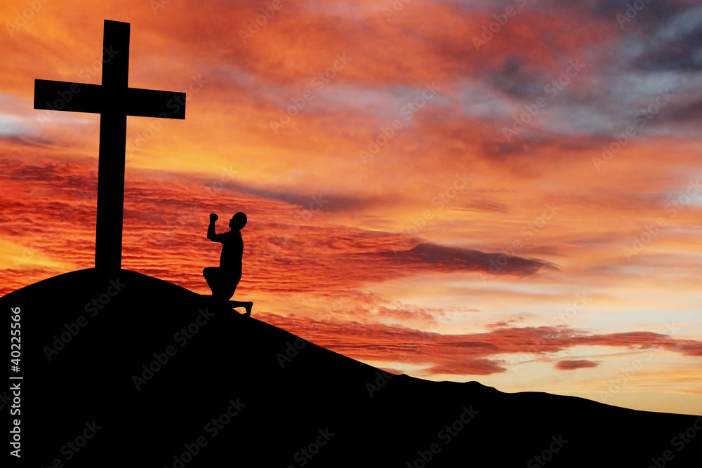 Silhouette of a man praying under the cross Stock Photo | Adobe Stock