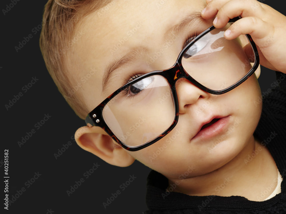 portrait of serious kid wearing glasses and doing a gesture over Stock ...