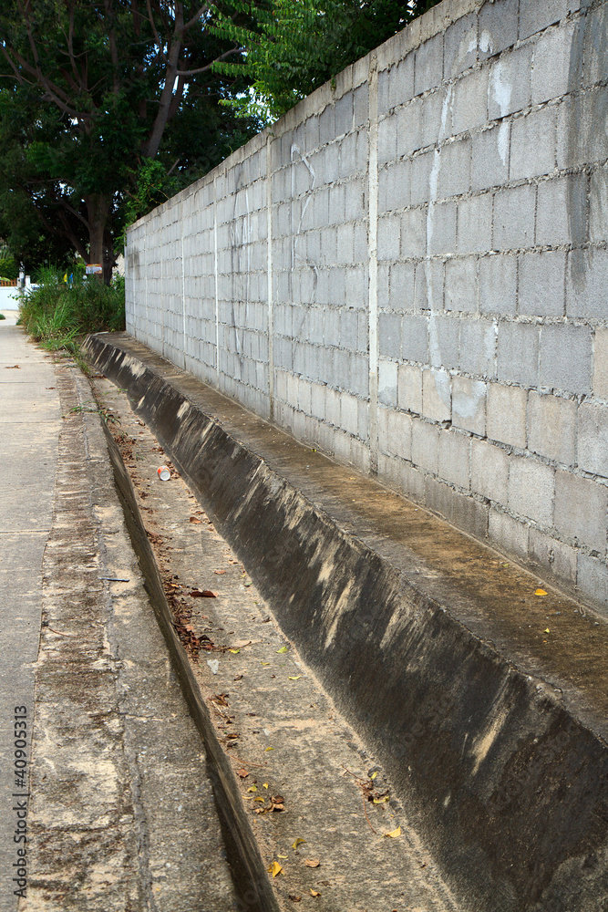 Brick walls, concrete drainage trough. Stock Photo | Adobe Stock