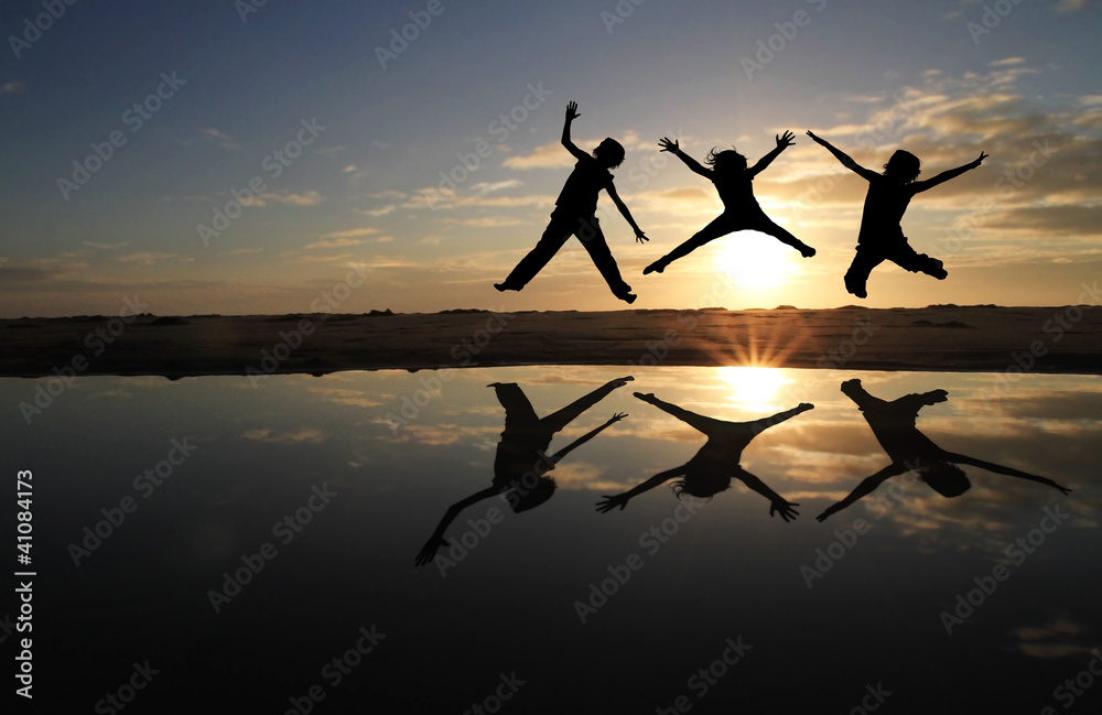 silhouette of kids jumping on beach in sunset Stock Photo | Adobe Stock