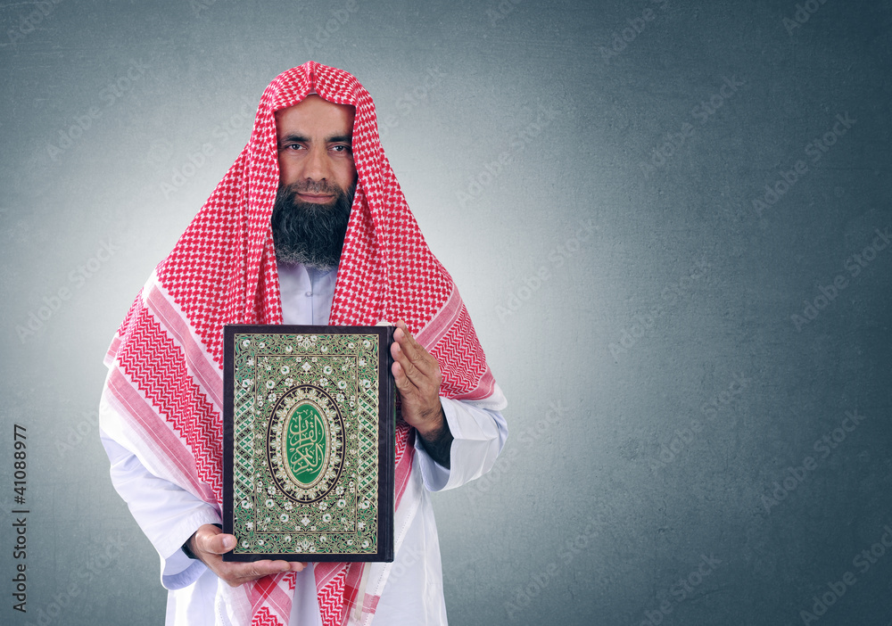 Islamic Arabian Sheikh presenting the holy book " Quran " Stock Photo ...
