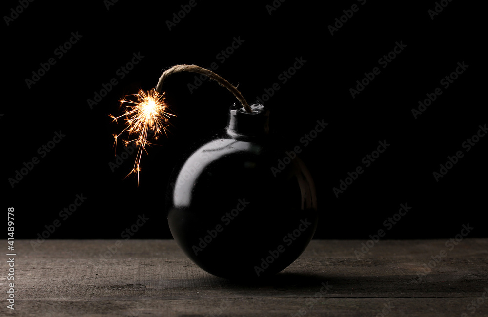 Cartoon style bomb on wooden table on black background Stock Photo ...