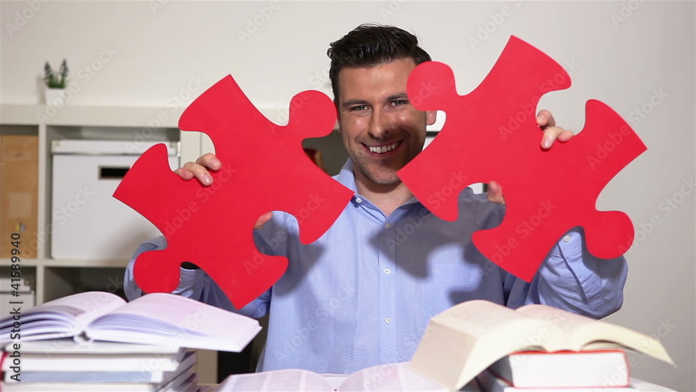 Student holding jigsaw puzzle pieces Stock Video | Adobe Stock