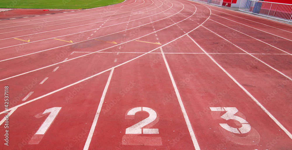 Lanes of a red race track with numbers and red seats in the stad Stock ...