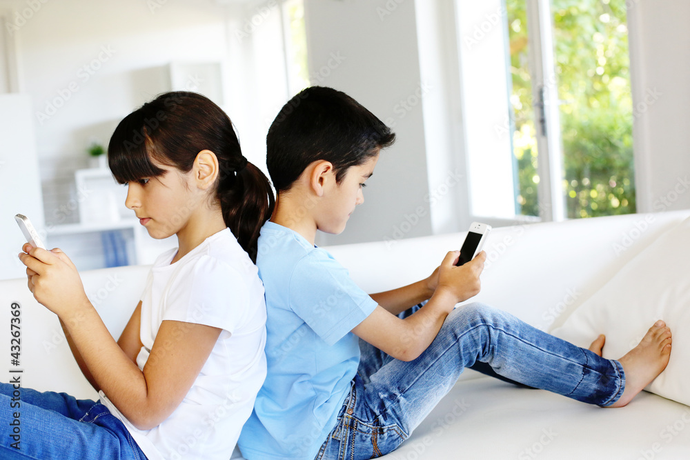Kids playing at home with smartphones Stock Photo | Adobe Stock