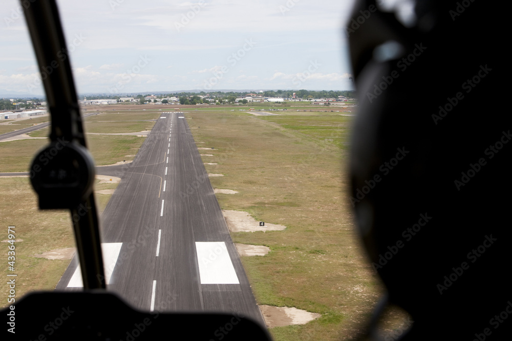 Cockpit view of airplane landing on airport runway Stock Photo | Adobe Stock