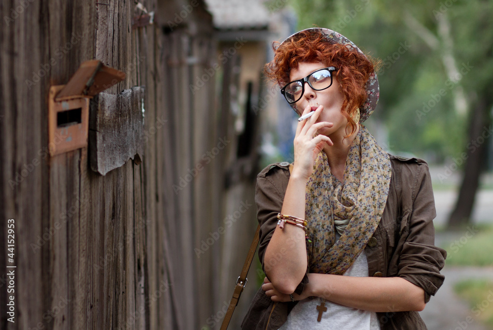 Diverse female model smoking a cigarette outdoor. Portrait of inclusive ...