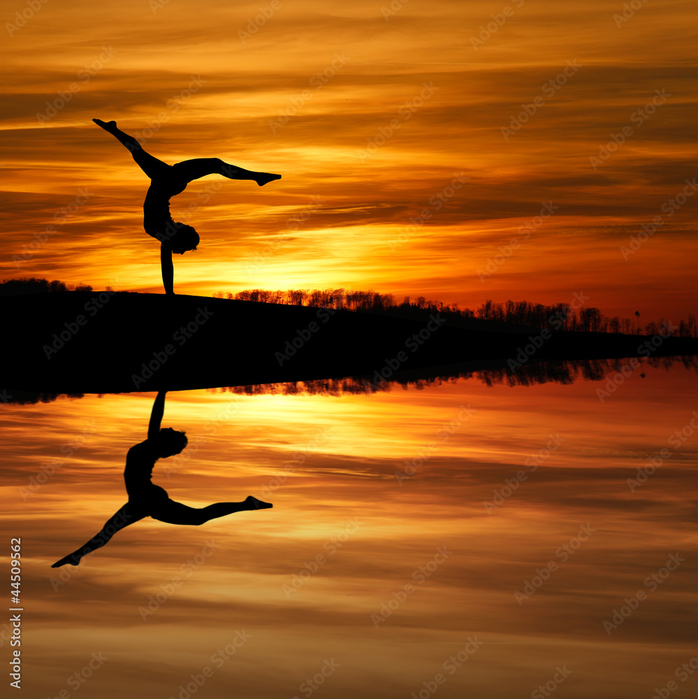 silhouette of female gymnast doing a handstand in sunset Stock Photo ...