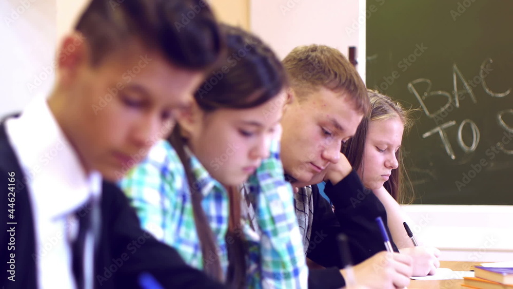 Faces of four attractive students writing task in line Stock Video ...