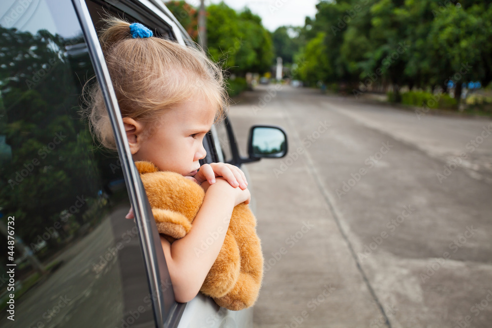 sad little girl sitting near the window in the car Stock Photo | Adobe ...