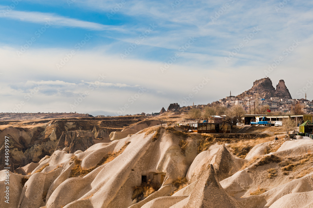 Ancient tuff stone caves and Uchisar castle in Goreme Cappadocia Stock ...
