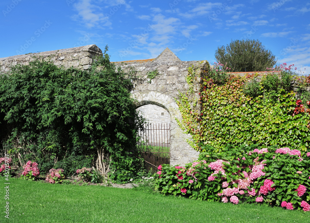 Gated arch through a Medieval Garden wall Stock Photo | Adobe Stock
