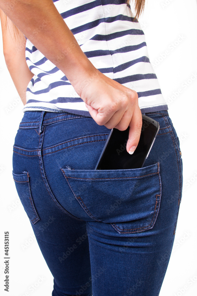 Cell phone in back pocket of girl's jeans Stock Photo | Adobe Stock