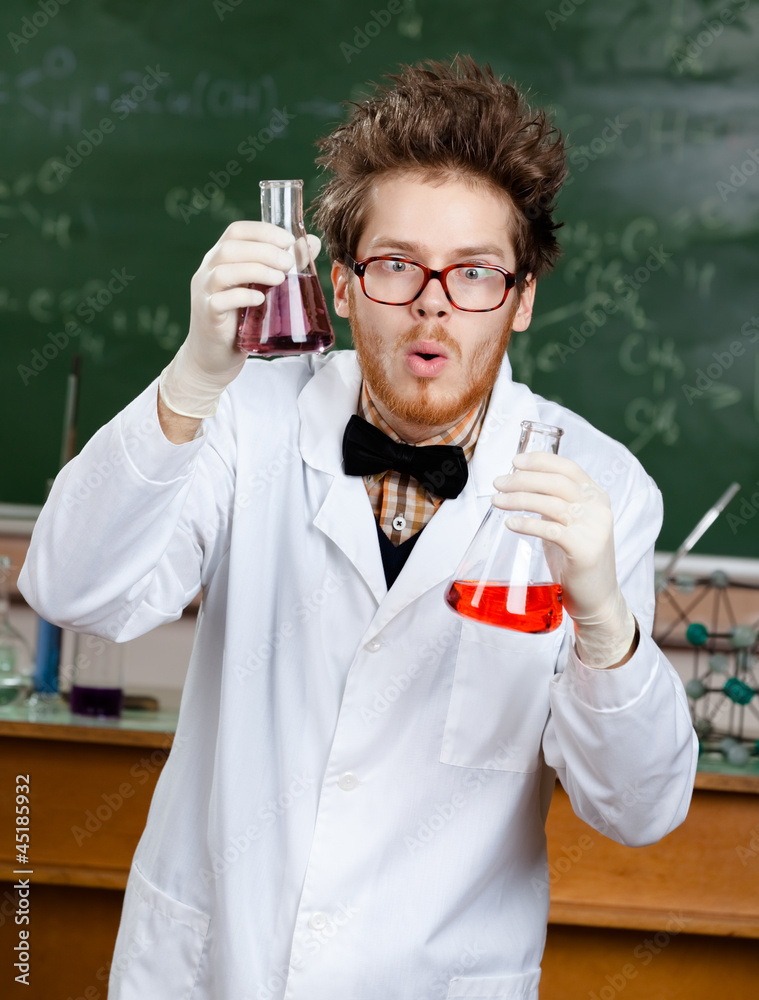 Mad scientist shows two flasks with colored liquid Stock Photo | Adobe ...