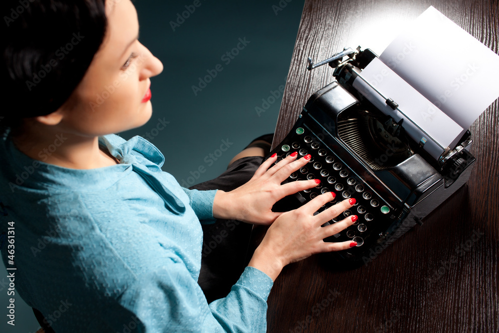 Young woman typing with old typewriter Stock Photo | Adobe Stock