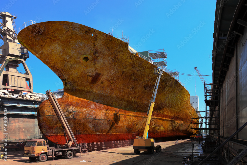 Workers sandblasting a large cargo ship from rust and corrosion Stock ...